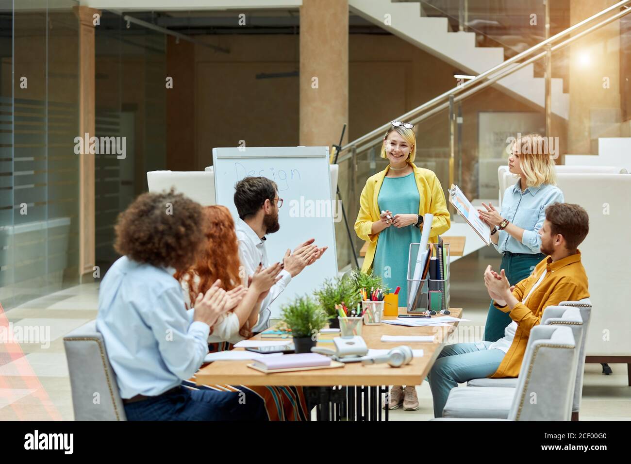 Group of delighted impressed young specialists cheerfully applaus, sit ...