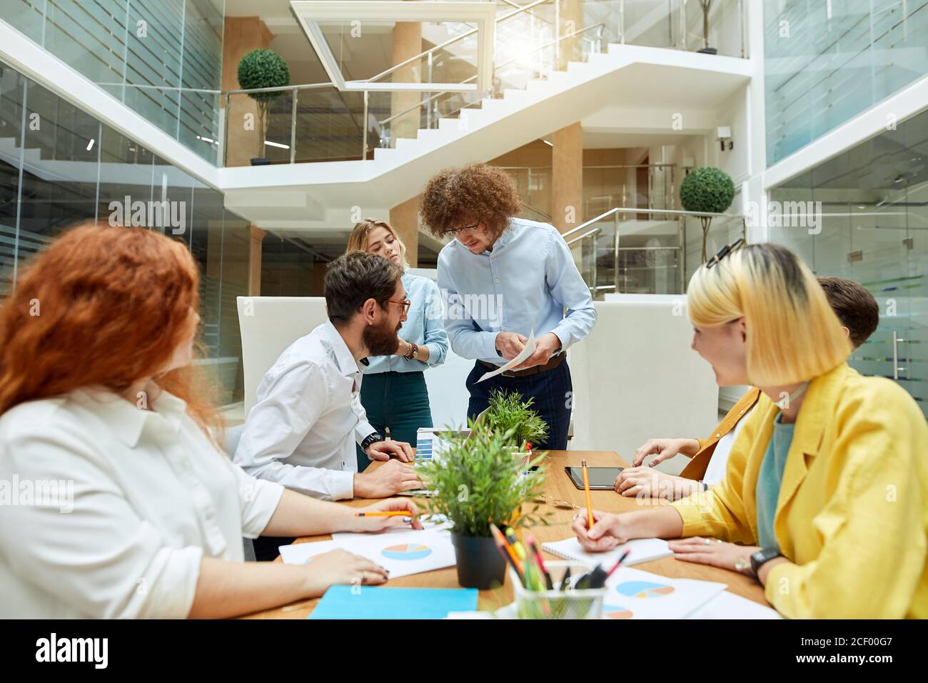 Serious handsome team leader explains work related issues, indicates ...
