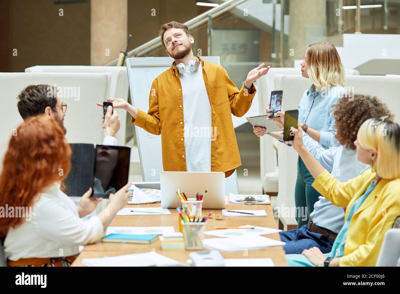 Successful handsome male coach stands in front of group of people ...
