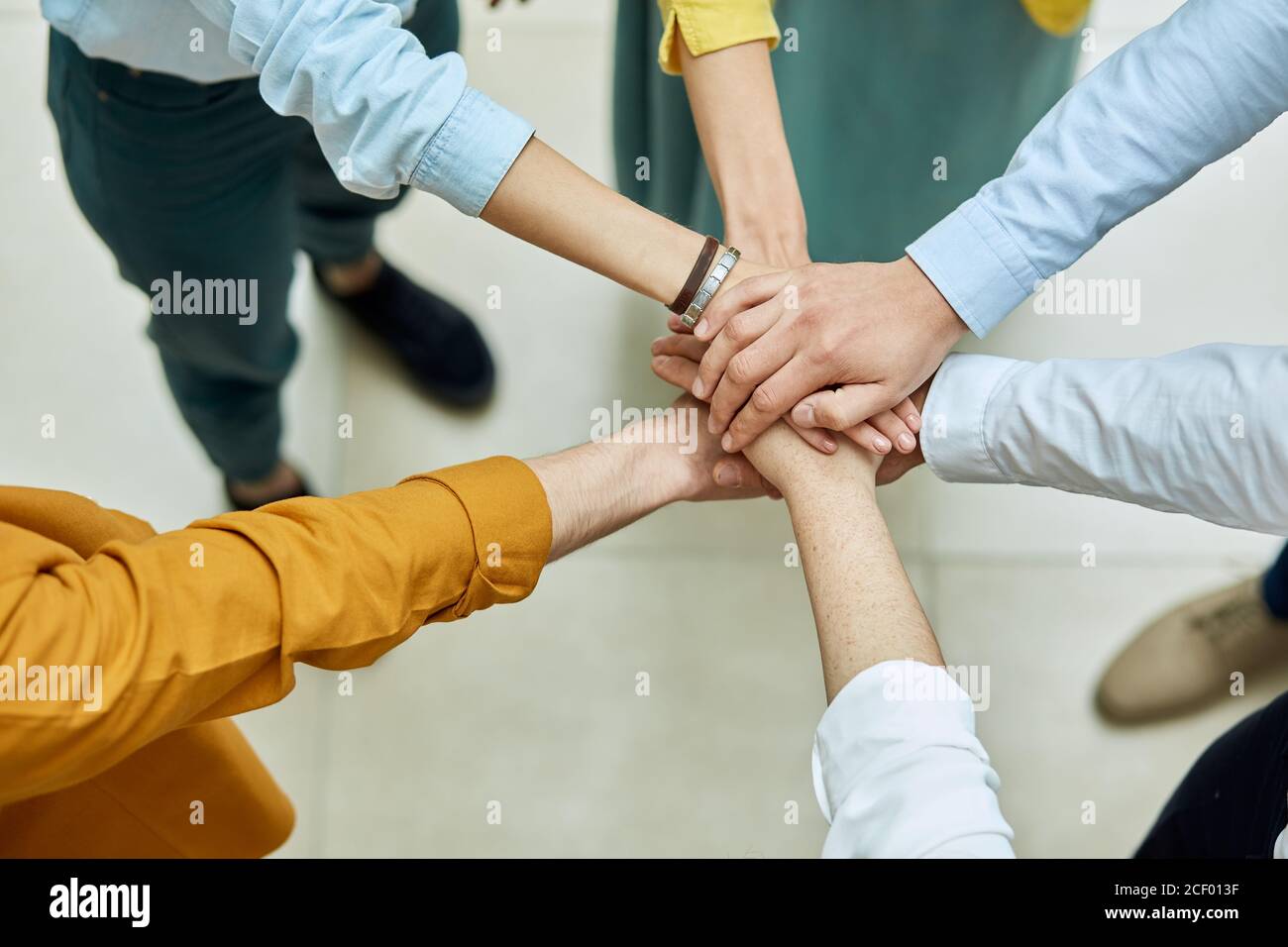 Friends keep hands together in sign of friendship and unity, shot from ...