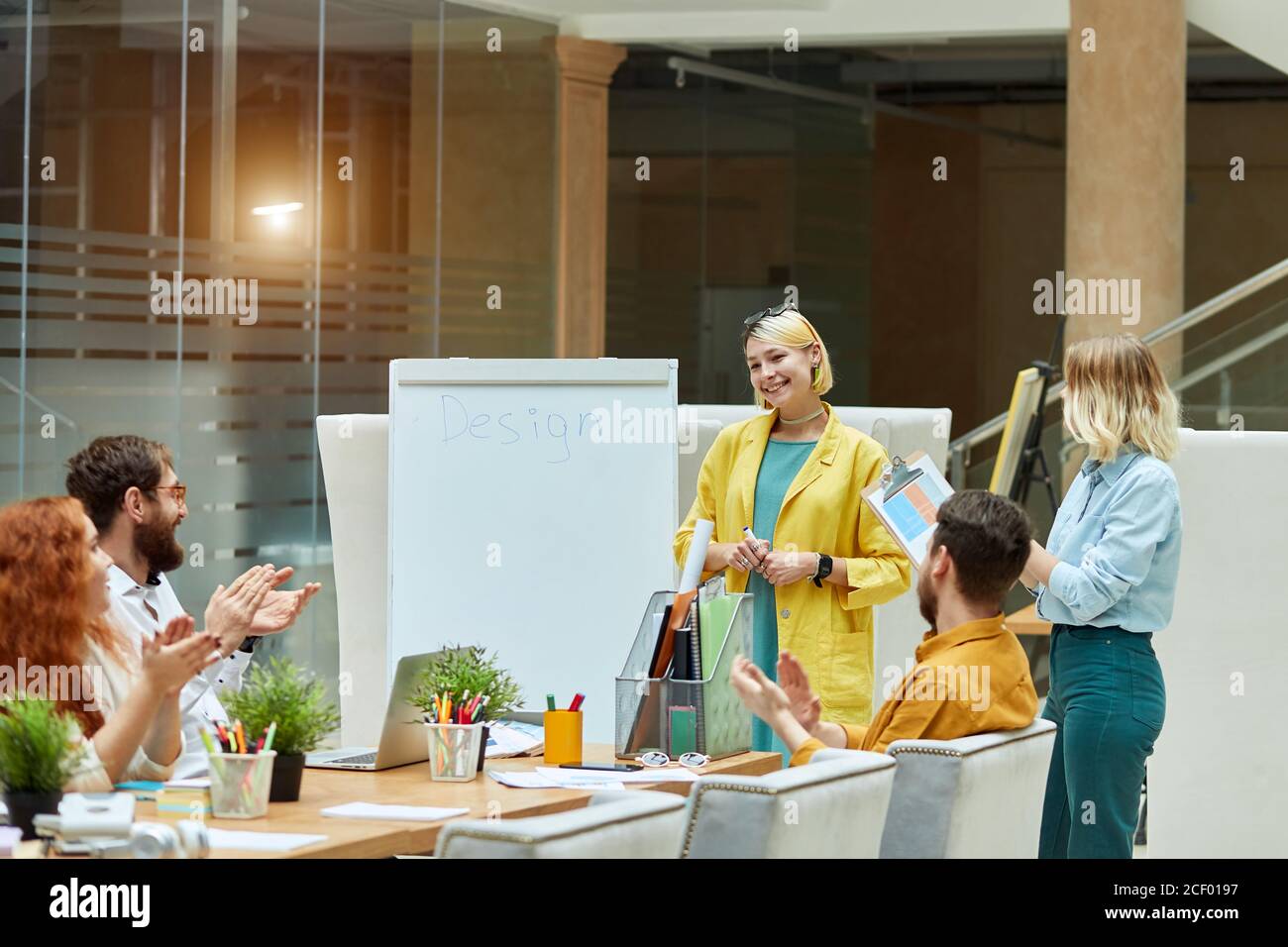 Optimistic impressed designers applauses to young cheerful satisfied ...