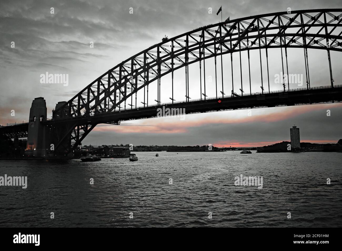 Sydney Harbour Bridge and Blues Point tower at sunset. A grayscale ...