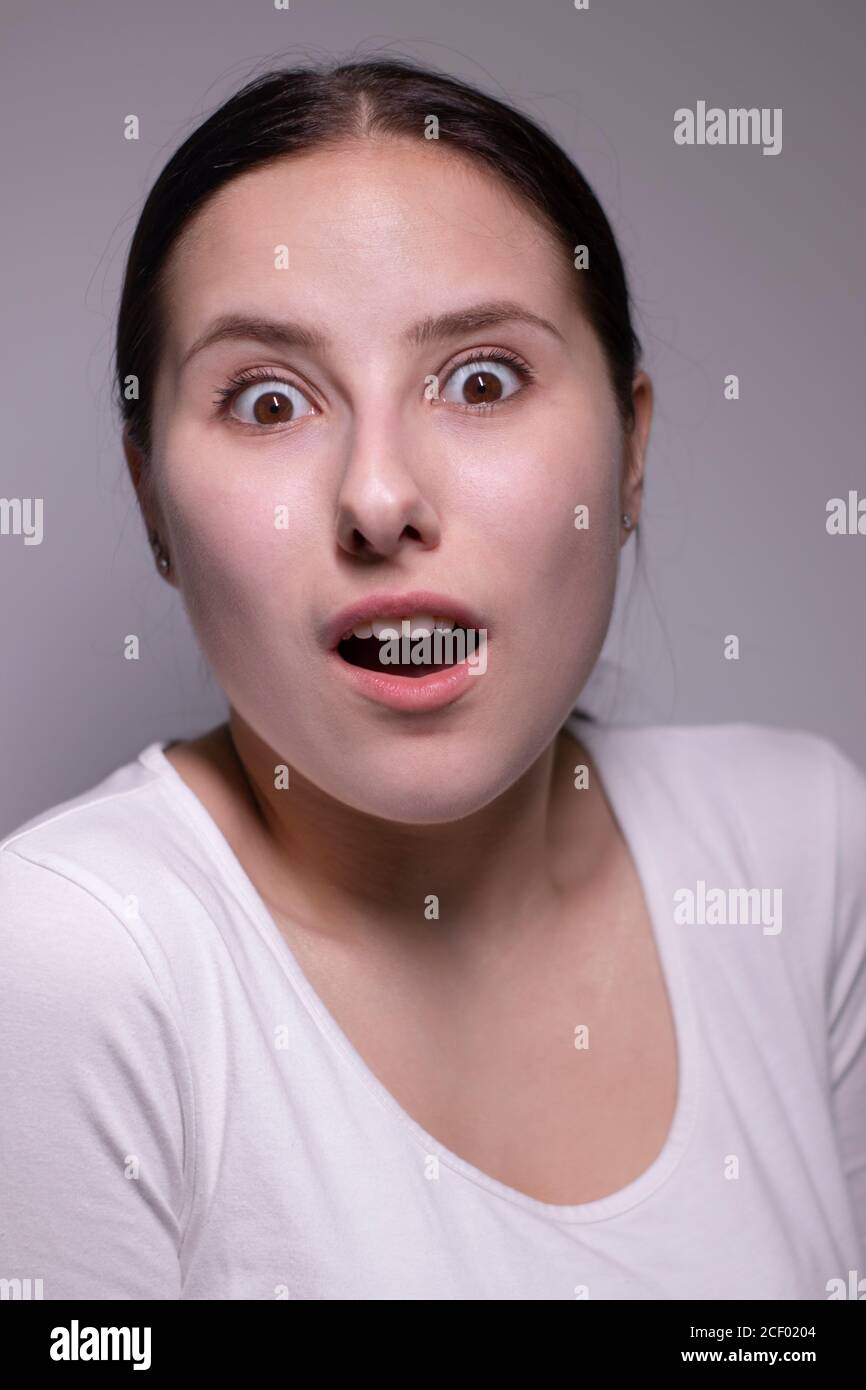surprised brunette, isolated on gray background. happy girl actress ...