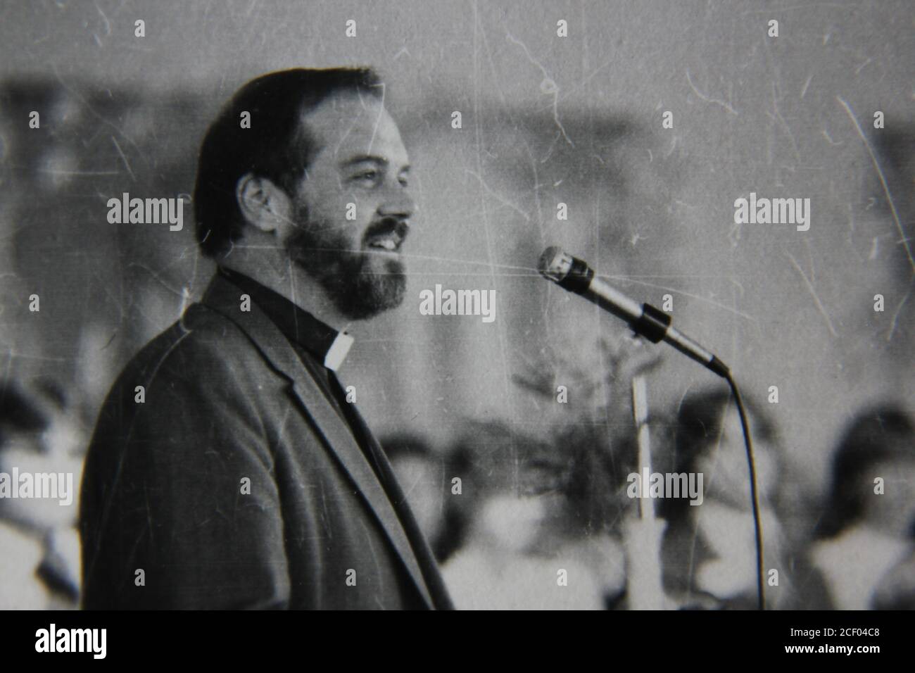 Fine 1970s vintage black and white photography of a priest giving a ...