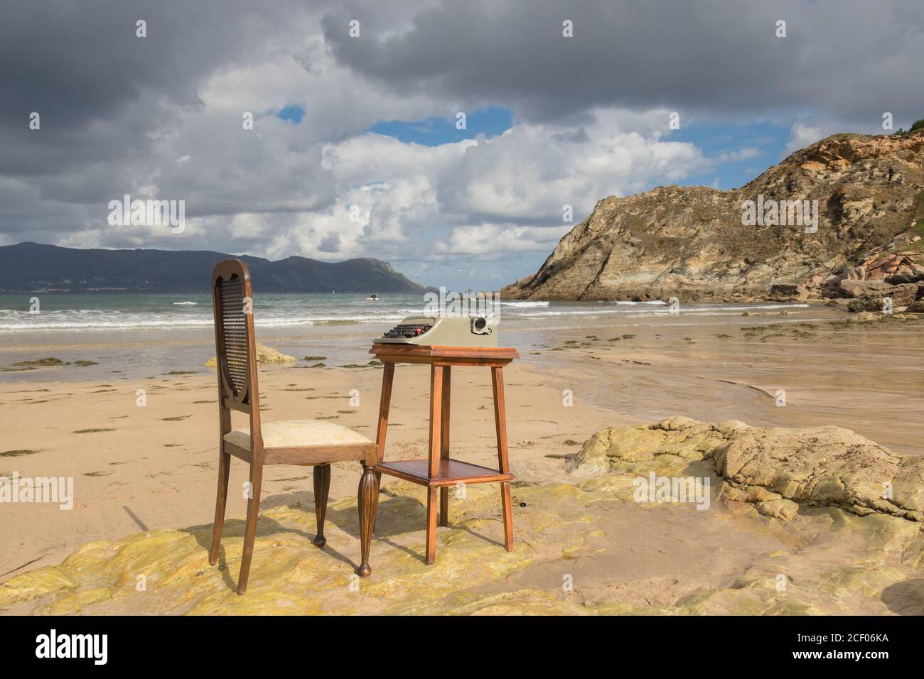 A nice scene for a writer. A chair, a typewriter and the sea to enhance ...