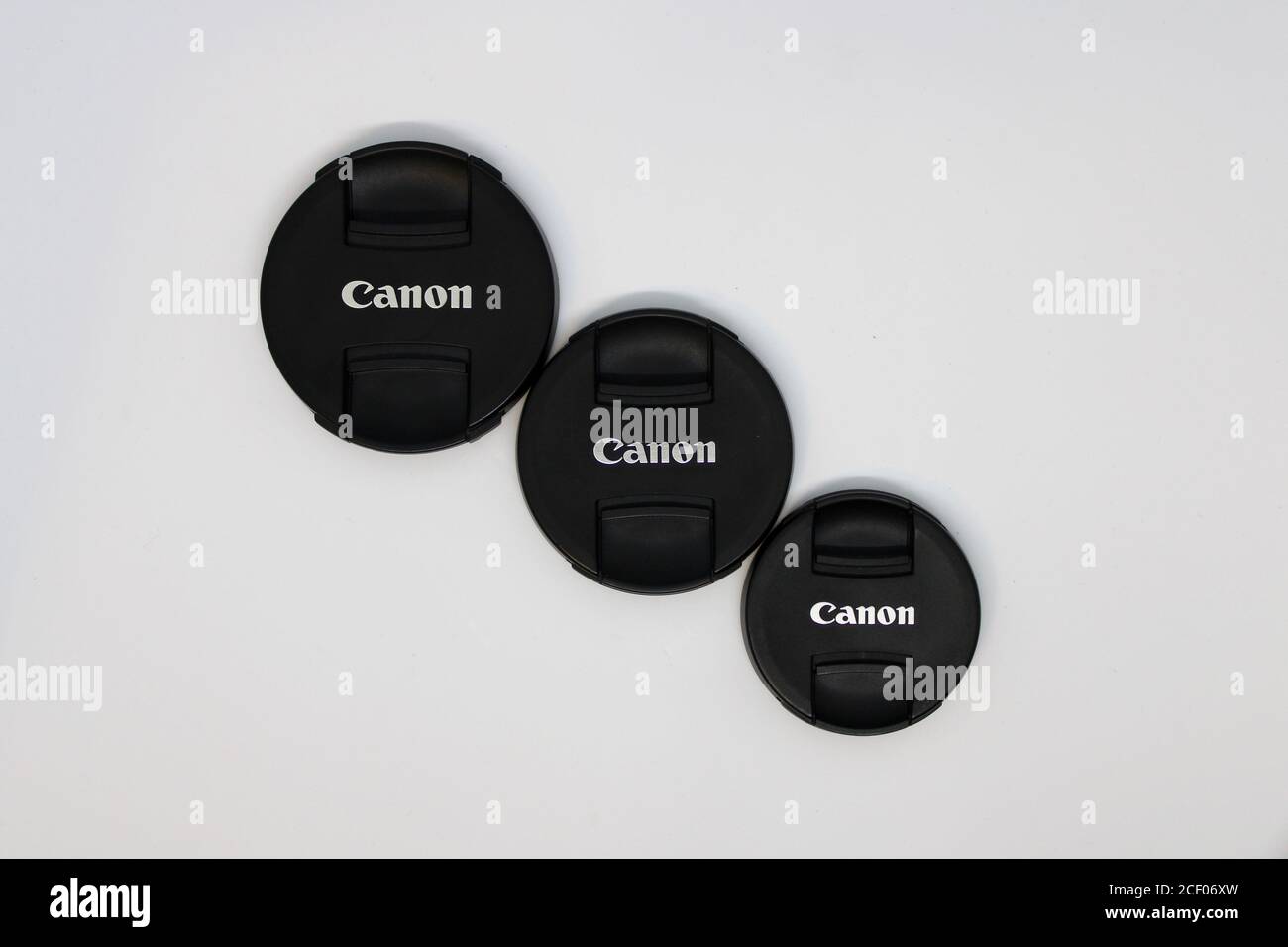 Three Canon Lens Caps of Different Sizes Stock Photo - Alamy