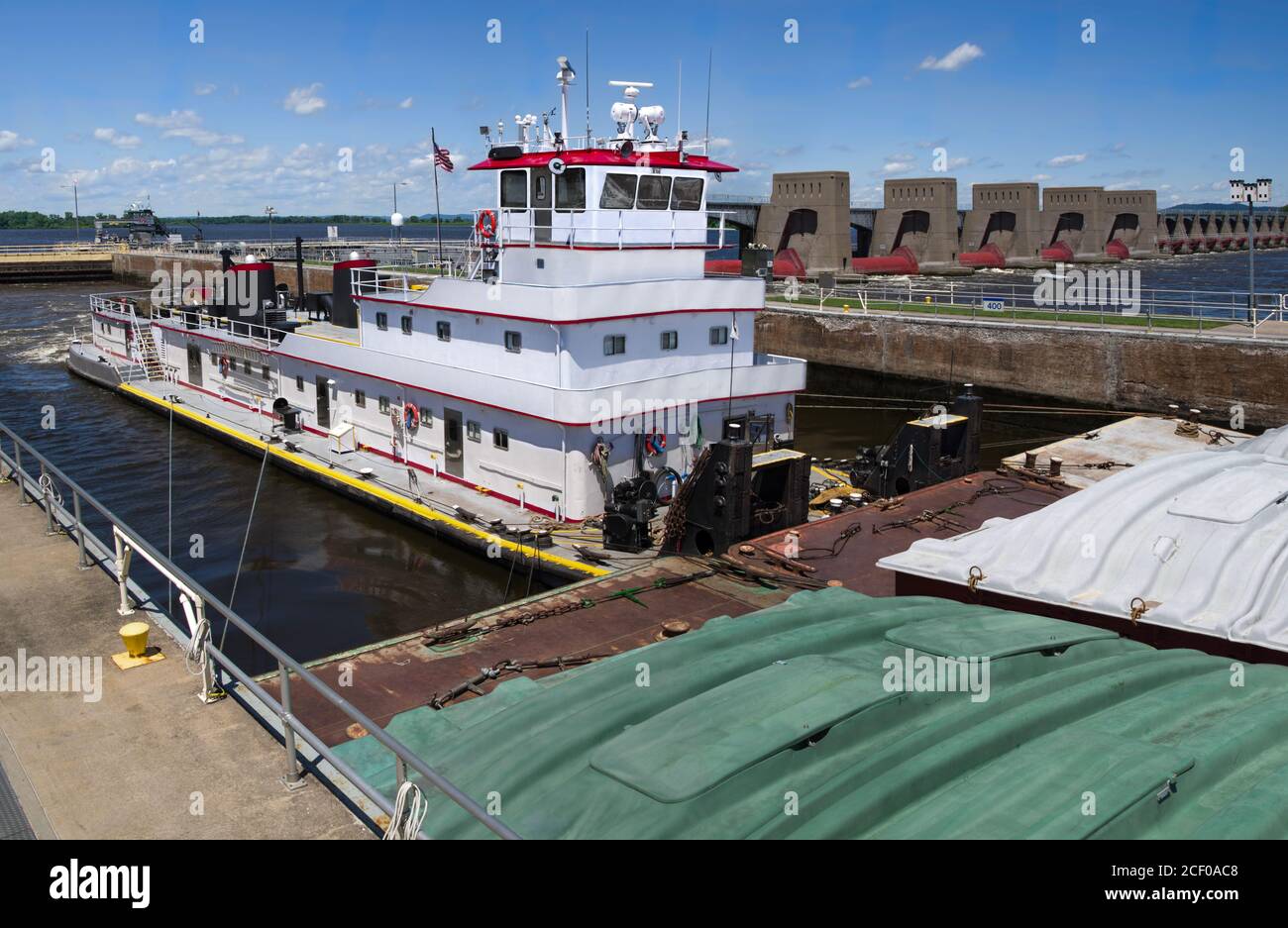 Pushing Barges: A towboat moves three rows of covered barges through a ...