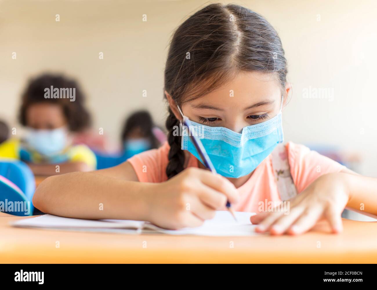 students wearing mask and studying in the classroom Stock Photo - Alamy