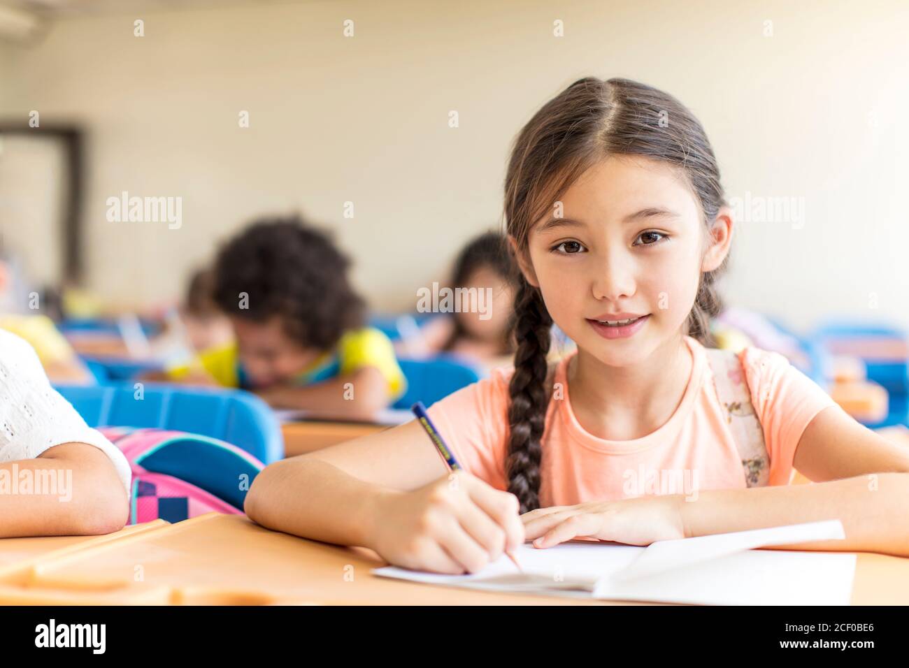 beautiful little girl studying in the classroom Stock Photo - Alamy