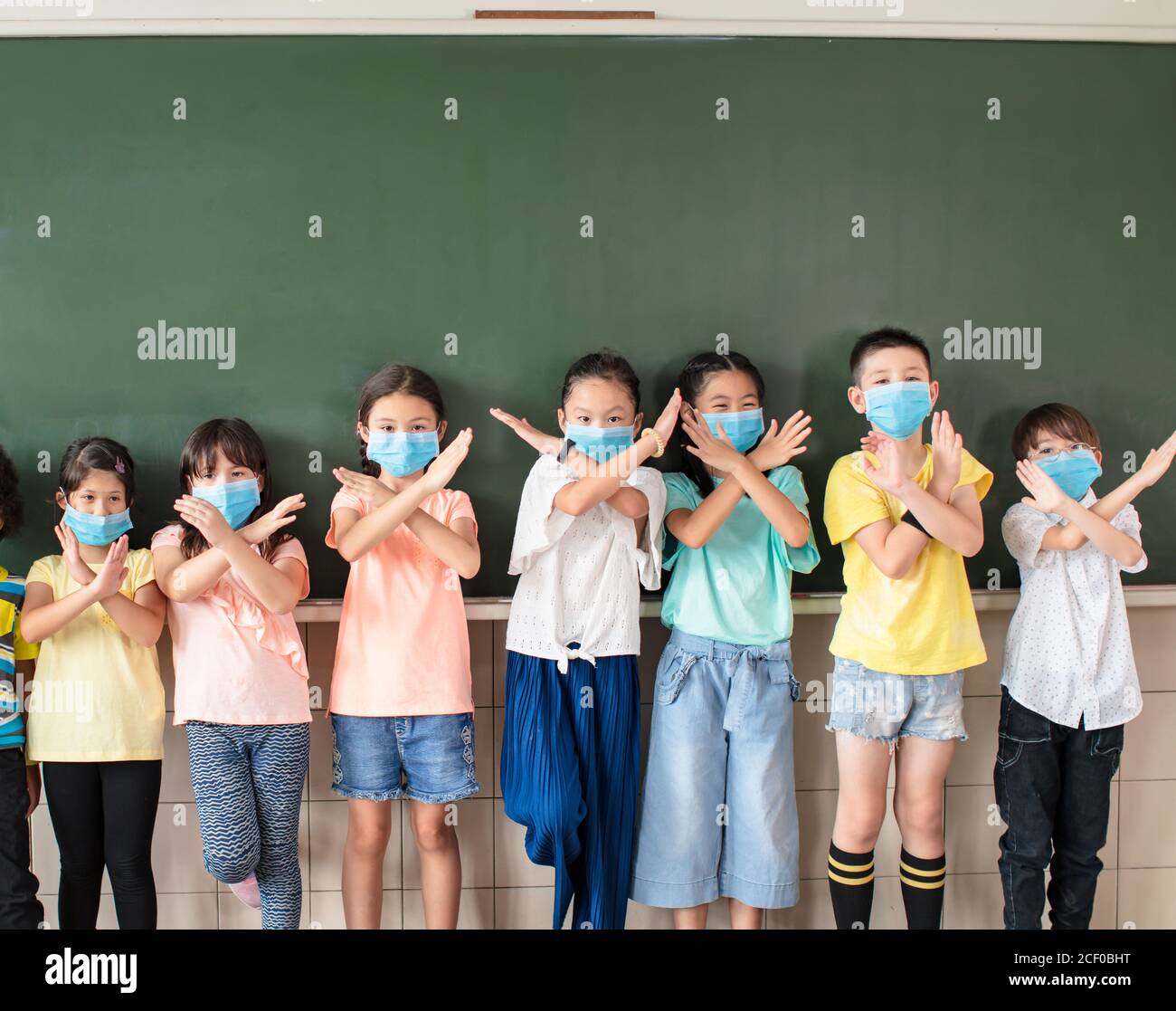 Group of diverse young students wear mask and showing stop sign gesture ...