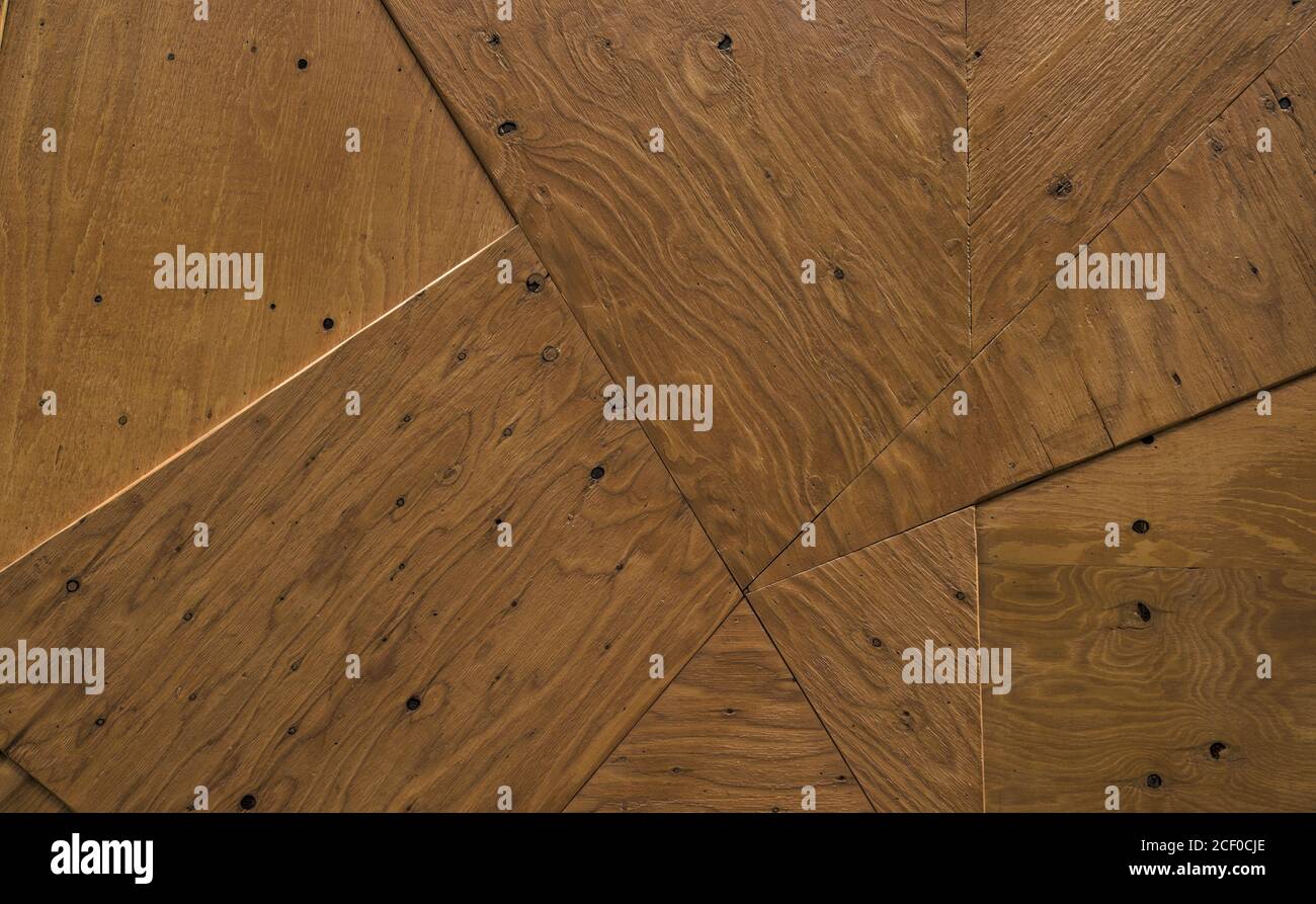 Textured surface of wooden boards cut and fit together in a triangular ...
