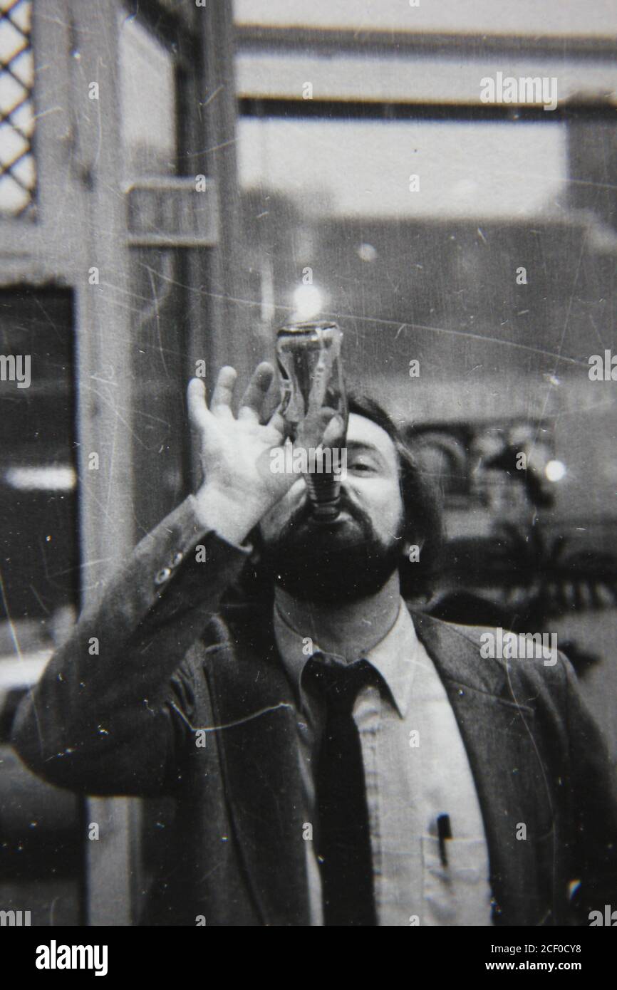Fine 1970s vintage black and white photography of a man doing bottoms ...
