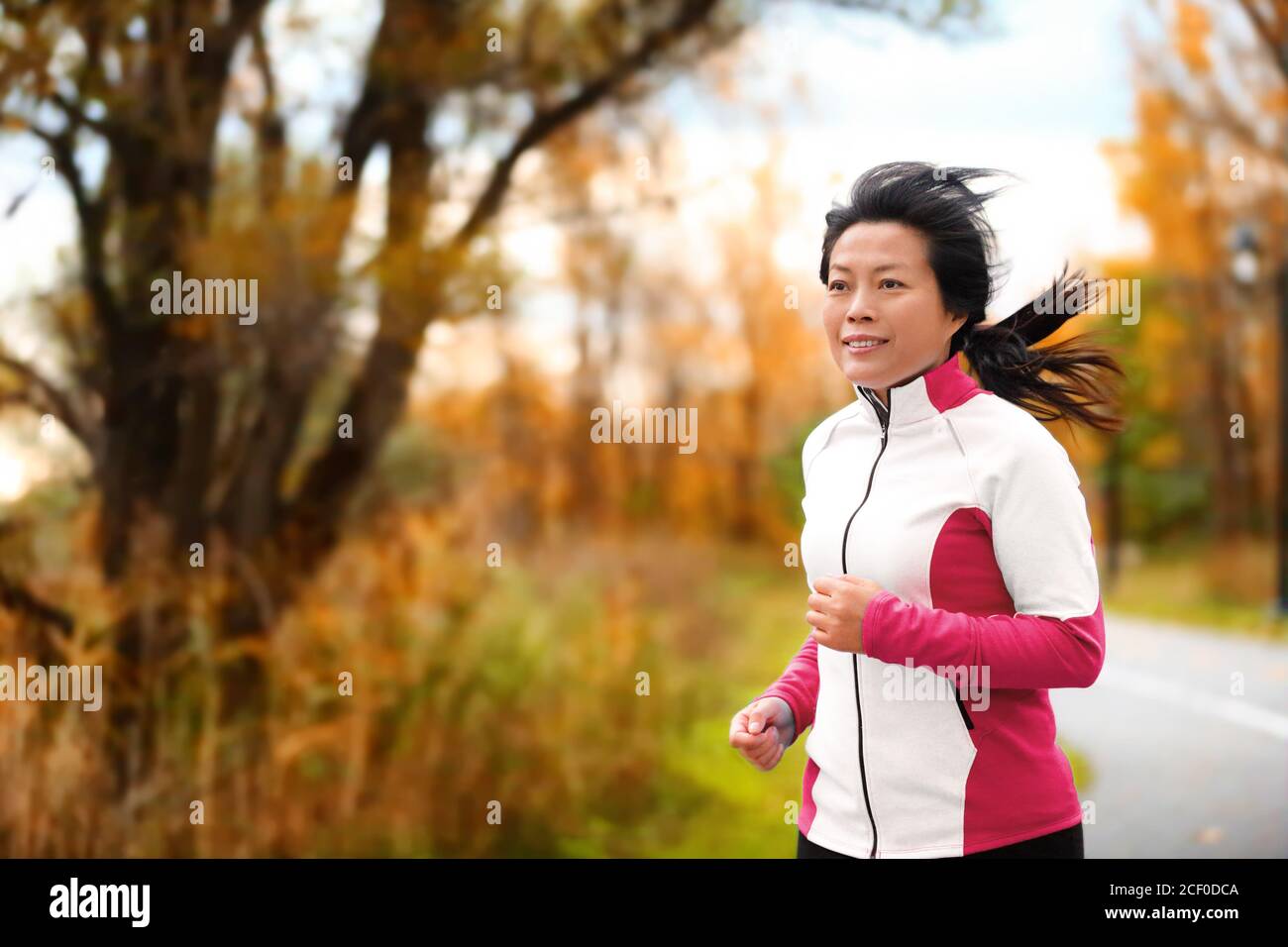 Mature Asian woman running living active lifestyle Stock Photo - Alamy