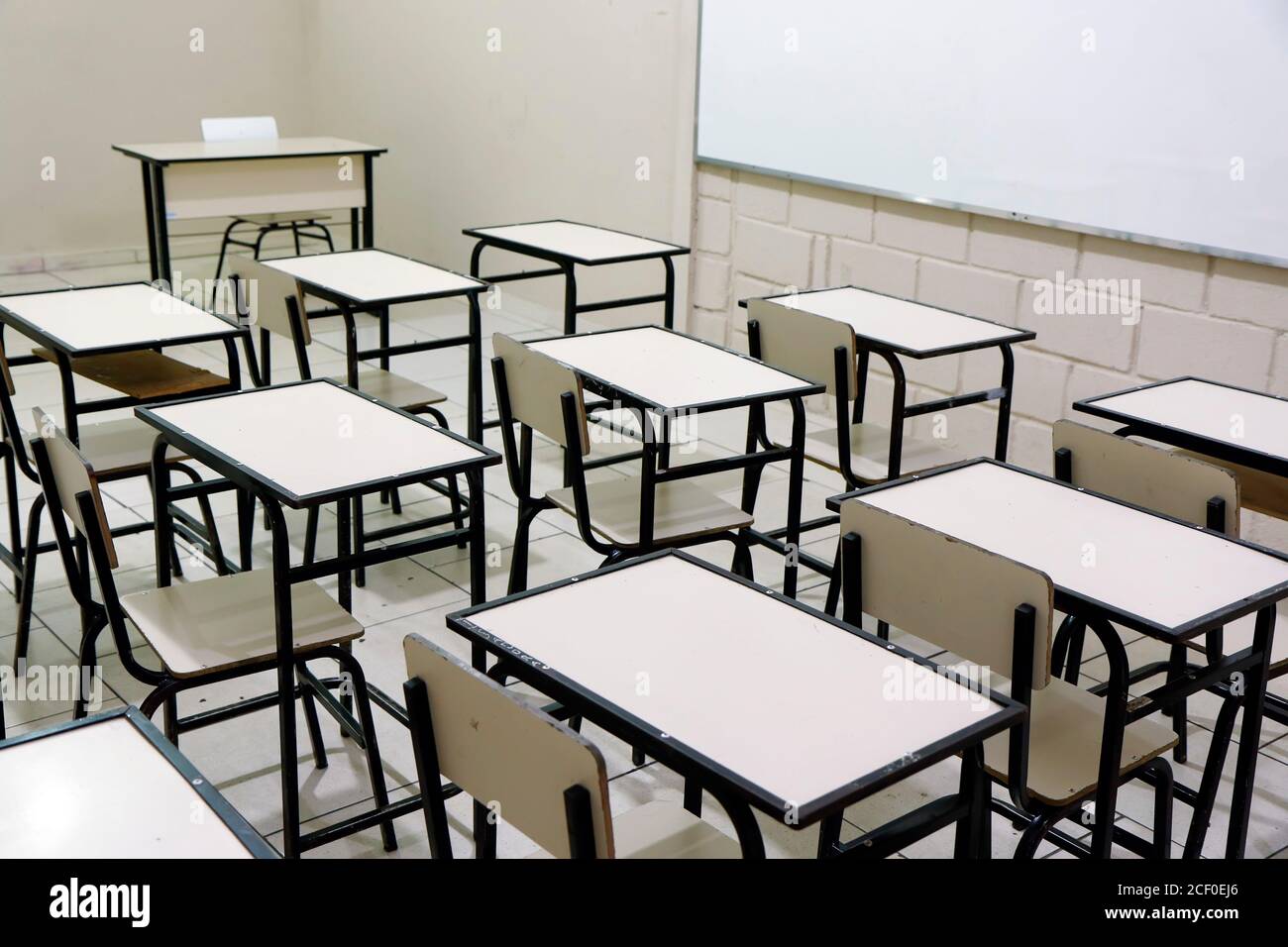 several tables and chairs in the classroom in an empty school without ...