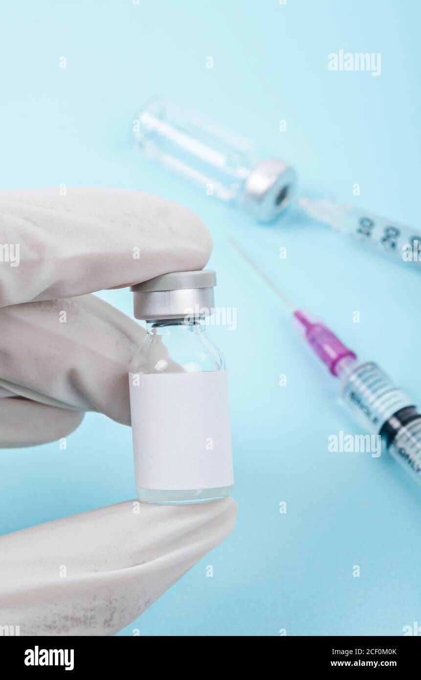 Medicine bottle for injection in hand with white glove. Medical glass ...