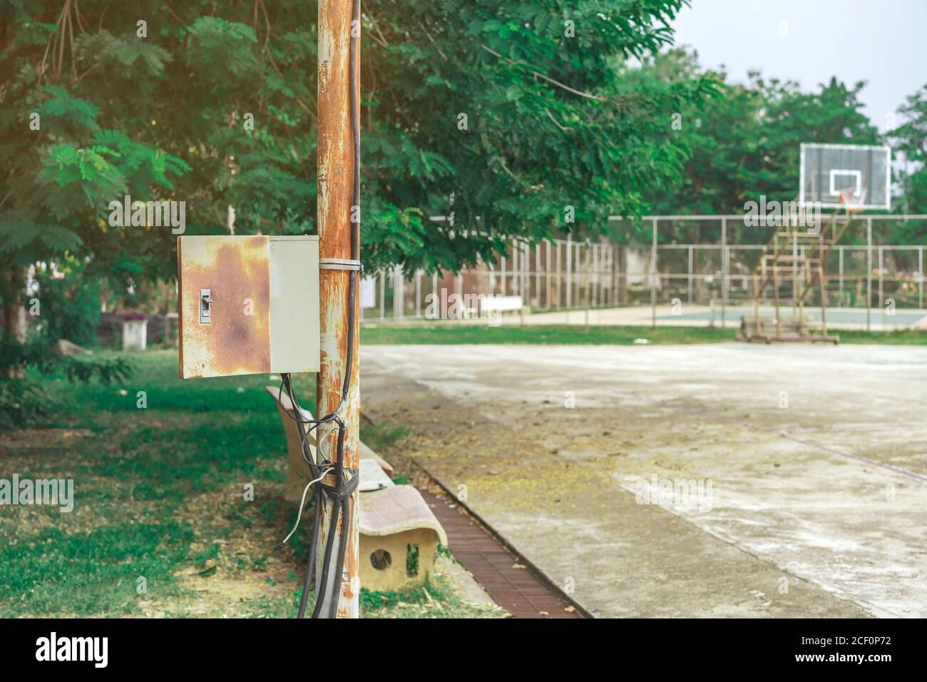 Old rusty electrical power control box on rusted electric pole in the ...