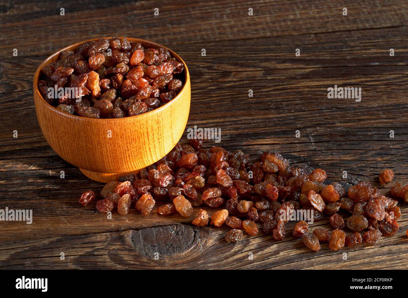 Raisins in the bowl on old wooden table in sunlight Stock Photo - Alamy