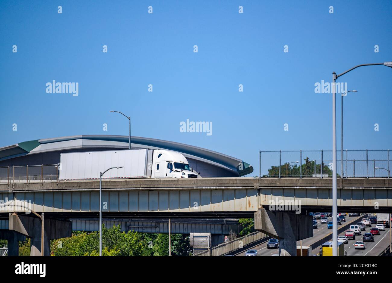 Big rig white industrial diesel semi truck transporting cargo in dry ...