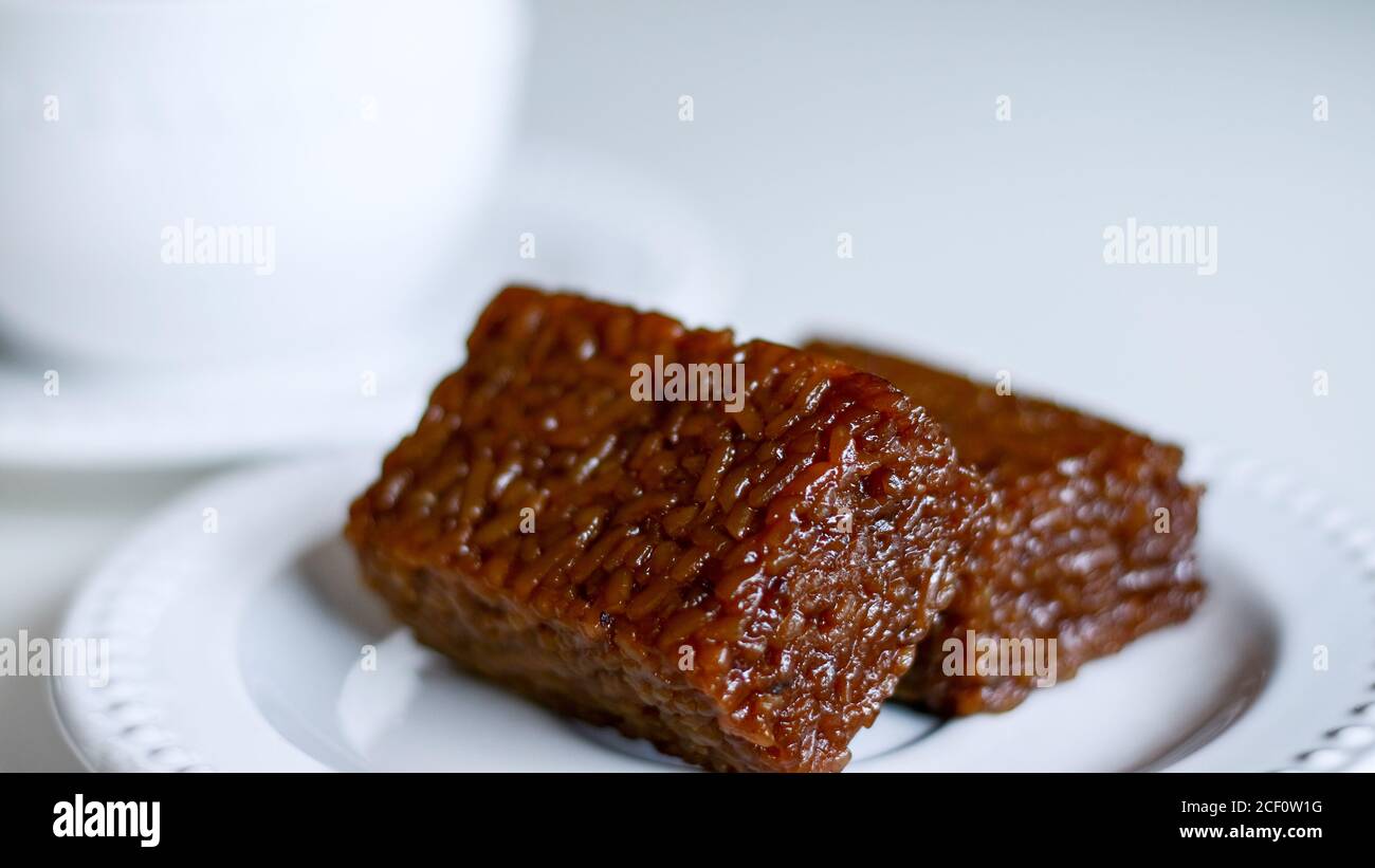 Wajik and a cup of tea on white background. Wajik is traditional snack ...