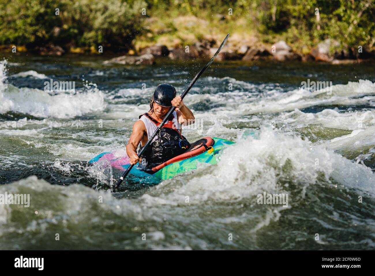 Guy in kayak boat overcomes threshold of mountain river, boiling water ...
