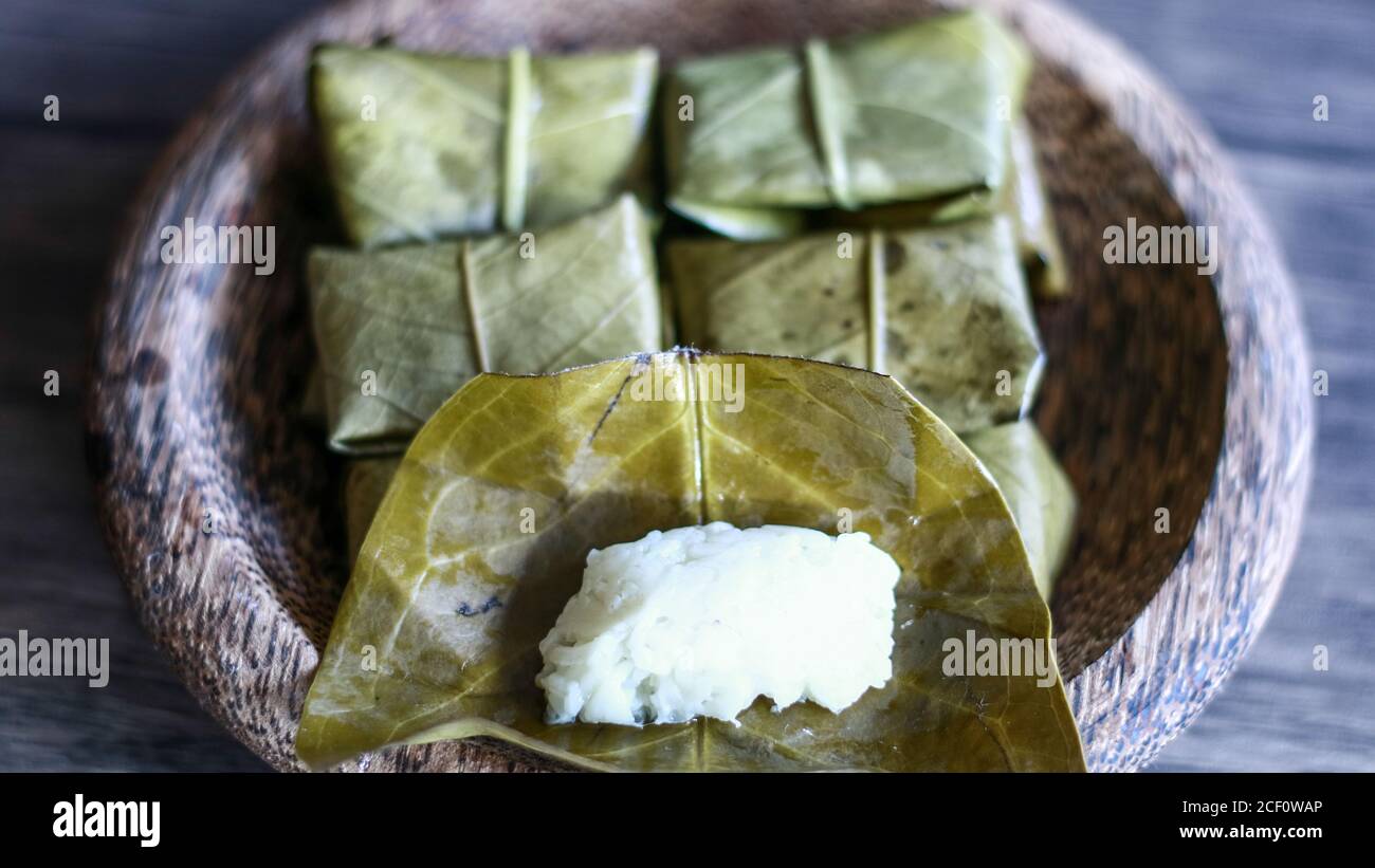 Fermented sticky (tape ketan) wrapped in guava leaves on wood ...