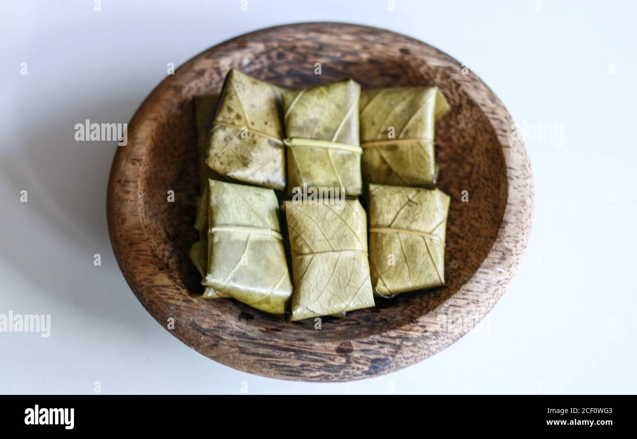 Fermented sticky (tape ketan) wrapped in guava leaves on white ...
