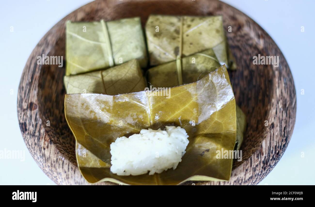 Fermented sticky (tape ketan) wrapped in guava leaves on white ...