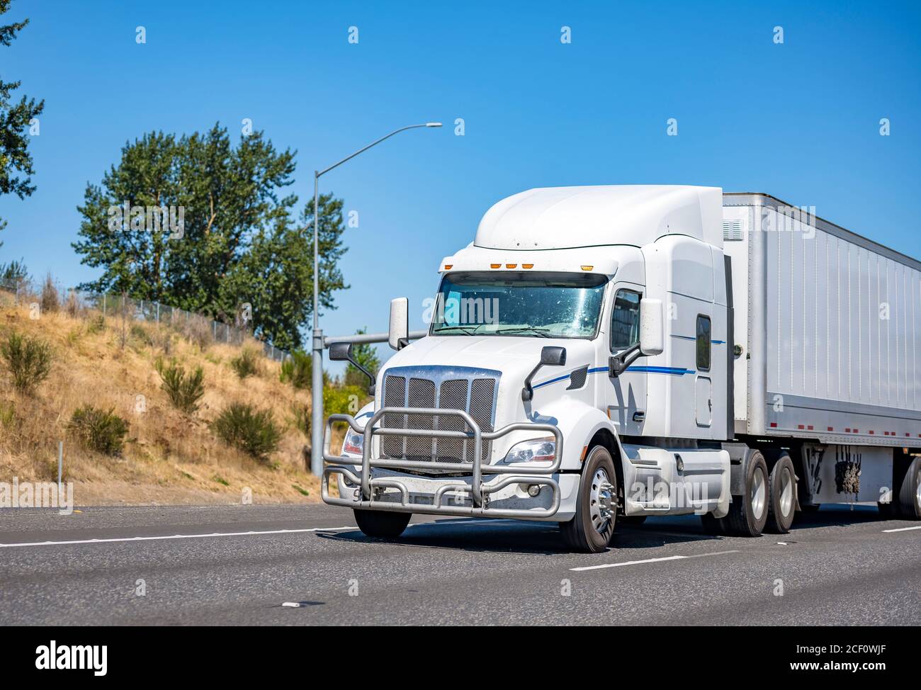 Powerful white big rig industrial diesel semi truck with grille guard ...