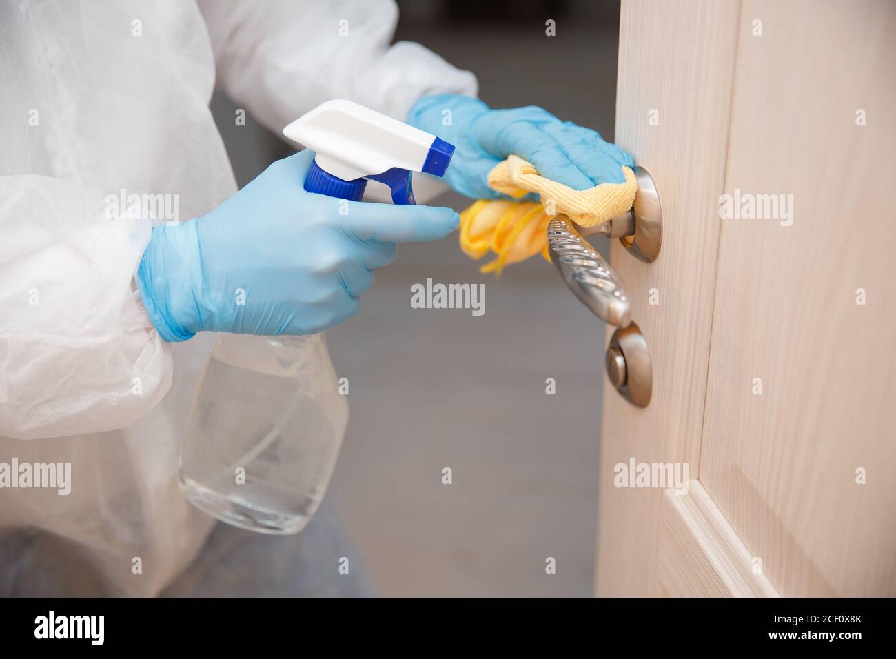 Disinfection and cleaning door handles of house from infection with ...