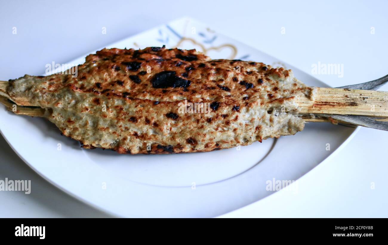 Milkfish satay or Sate Bandeng on white plate. Traditional food from ...