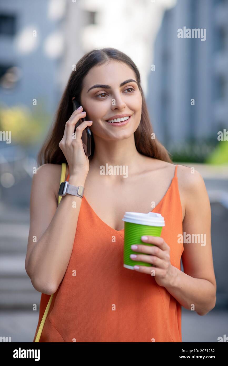 Joyous female holding smartphone hi-res stock photography and images ...