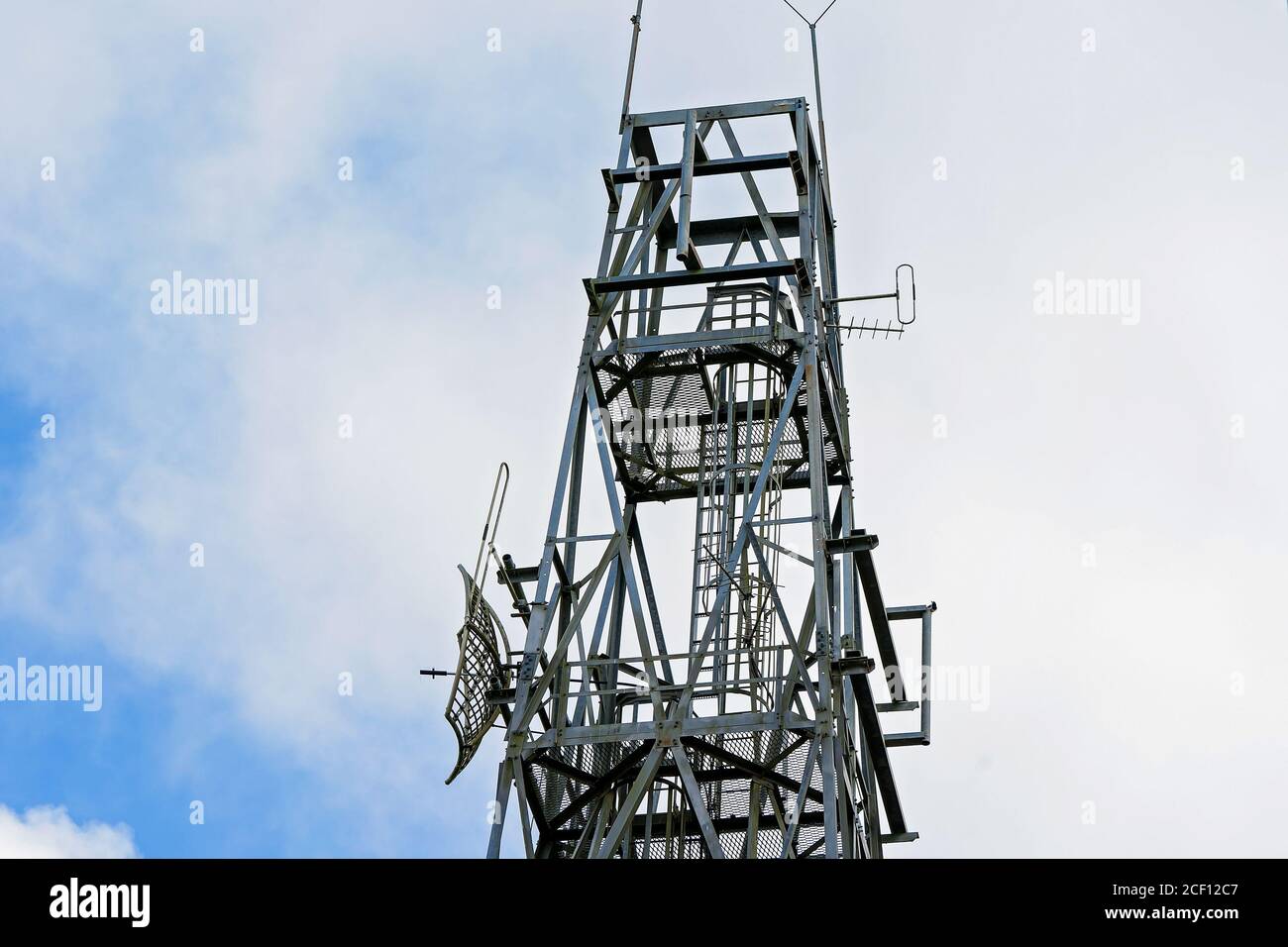 Modern technology communication towers against a cloudy blue sky Stock ...