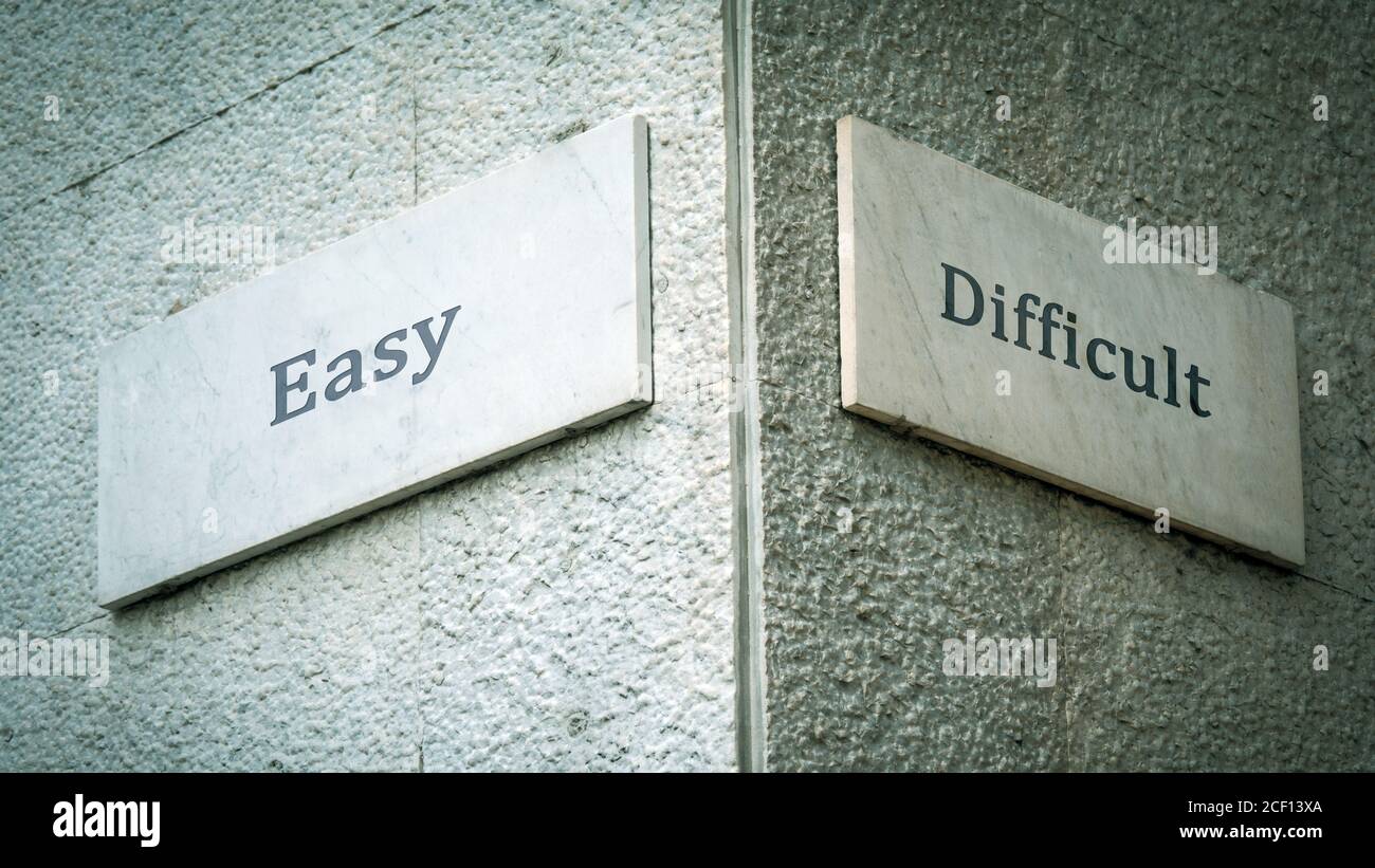 Street Sign the Direction Way to Easy versus Difficult Stock Photo - Alamy