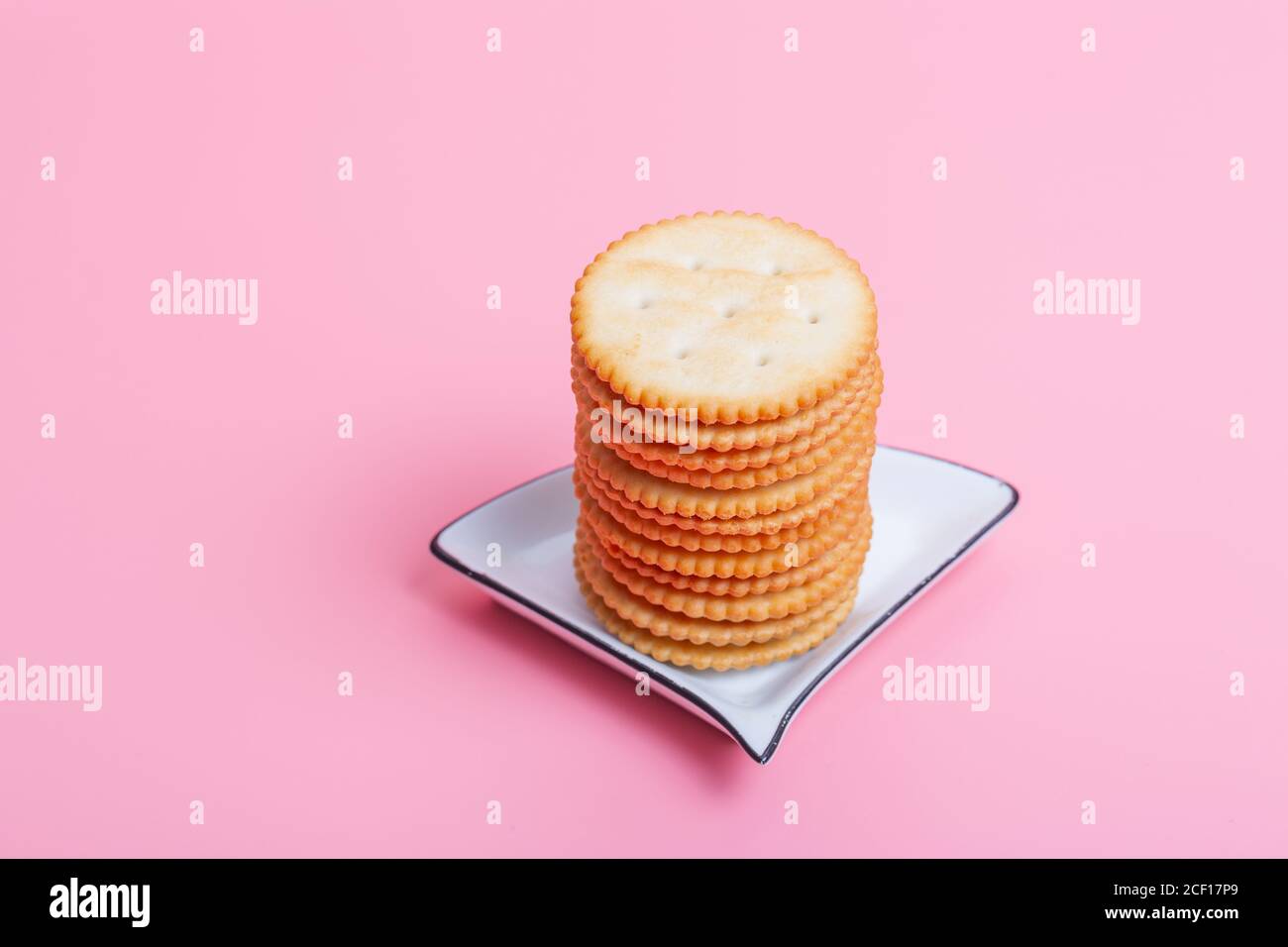 Cream sandwich biscuits on pink background Stock Photo - Alamy