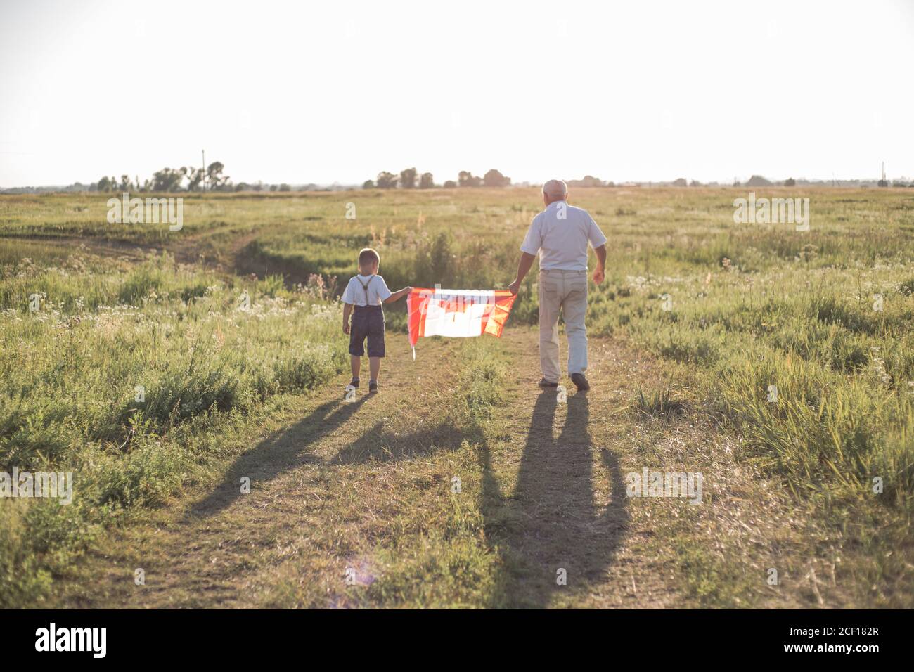 Attractive old senior man and grahdson holding Canadian Flag. National ...