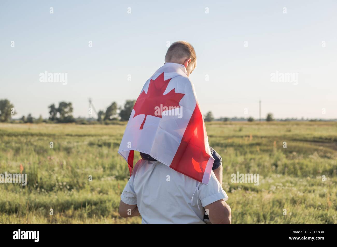Attractive old senior man and grahdson holding Canadian Flag. National ...