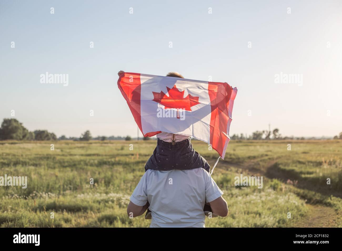 Attractive old senior man and grahdson holding Canadian Flag. National ...