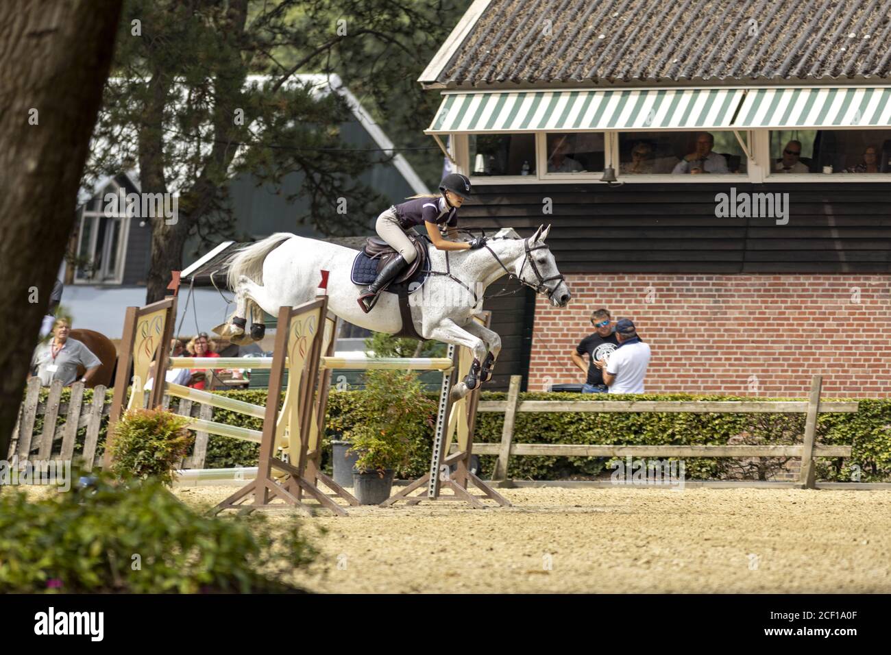 HOGE HEXEL, NETHERLANDS - Aug 15, 2020: Young female horseback rider ...