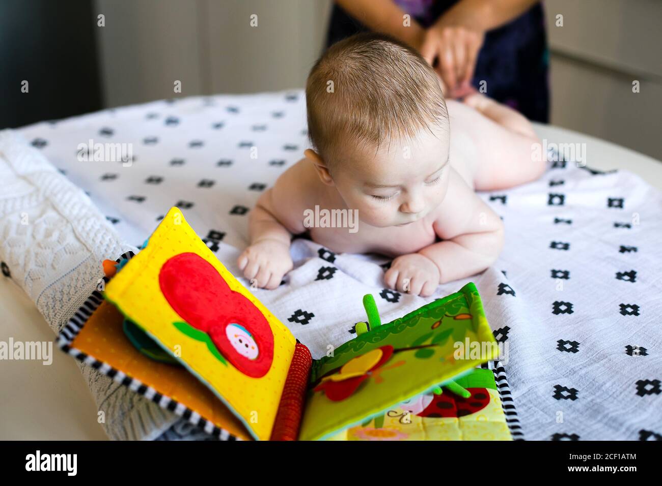 Mother makes newborn baby massage apply oil on the hand Stock Photo - Alamy