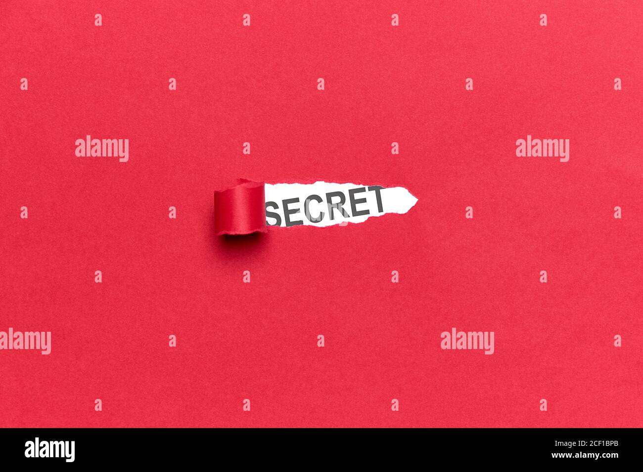 Broken red cardboard and the word SECRET appears below. Background ...