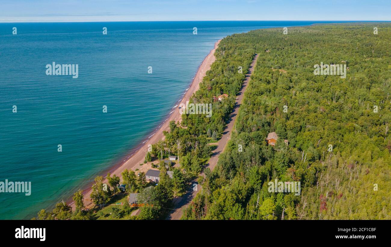 Aerial view of the sea and seaside buildings surrounded by greenery ...