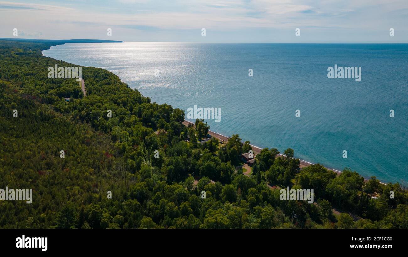 Aerial view of the sea and seaside buildings surrounded by greenery ...