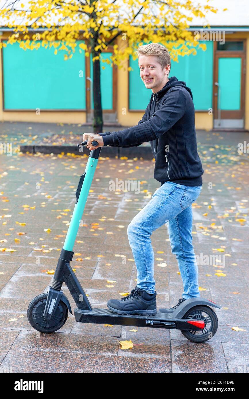 Young dutch man driving electric scooter on the road in Finland Stock ...