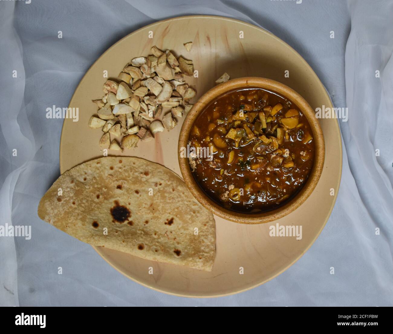 seasonal mushroom vegetable with bread/chapati on a white background ...