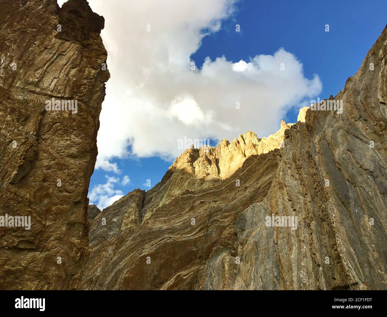 Low angle shot of jagged cliffs against a cloudy sky in Ladakh, India ...