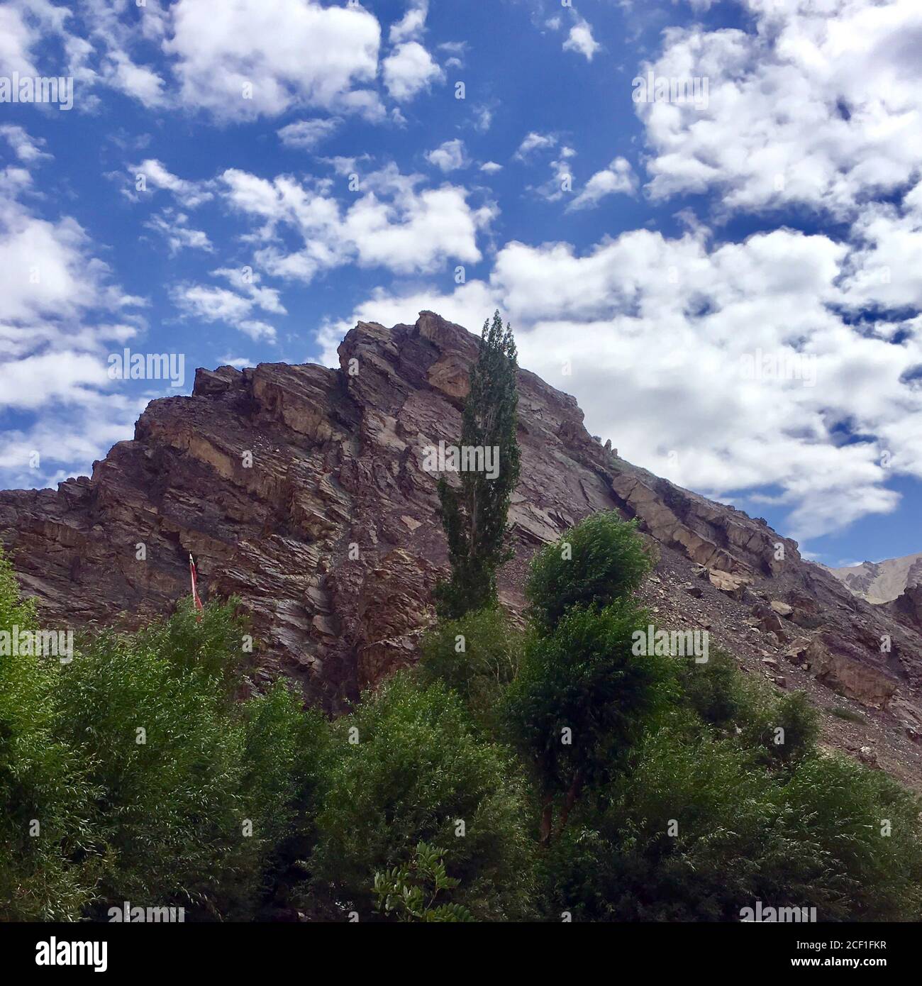 Low angle shot of jagged cliffs against a cloudy sky in Ladakh, India ...