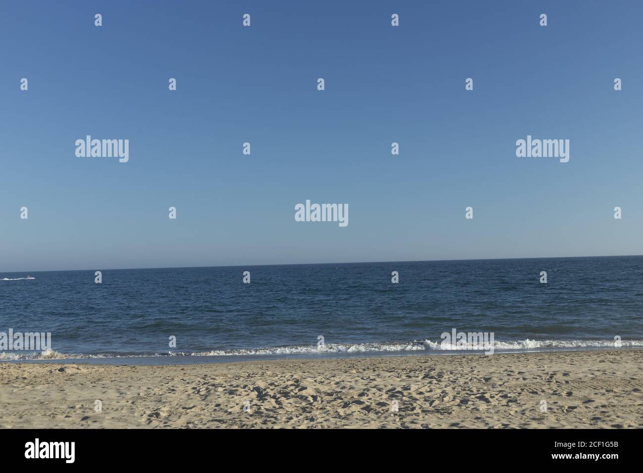 Beautiful scenery of a clean beach under a clear blue sky Stock Photo ...