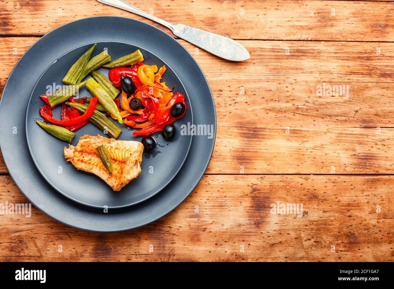 Baked fish with okra and red pepper.Fish grenadier Stock Photo - Alamy