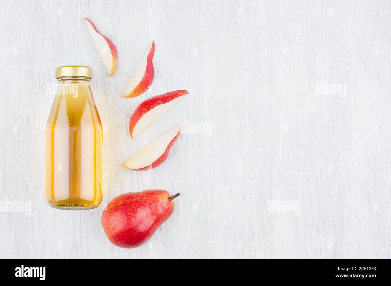 Bright transparent yellow pear juice in glass bottle as template for ...