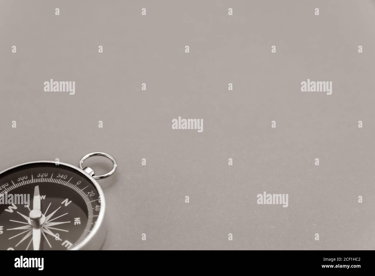 Compass isolated on a grey background Stock Photo - Alamy